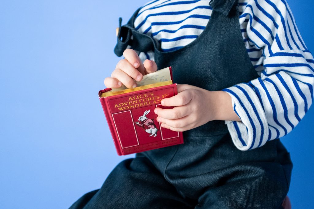 Child holding red book